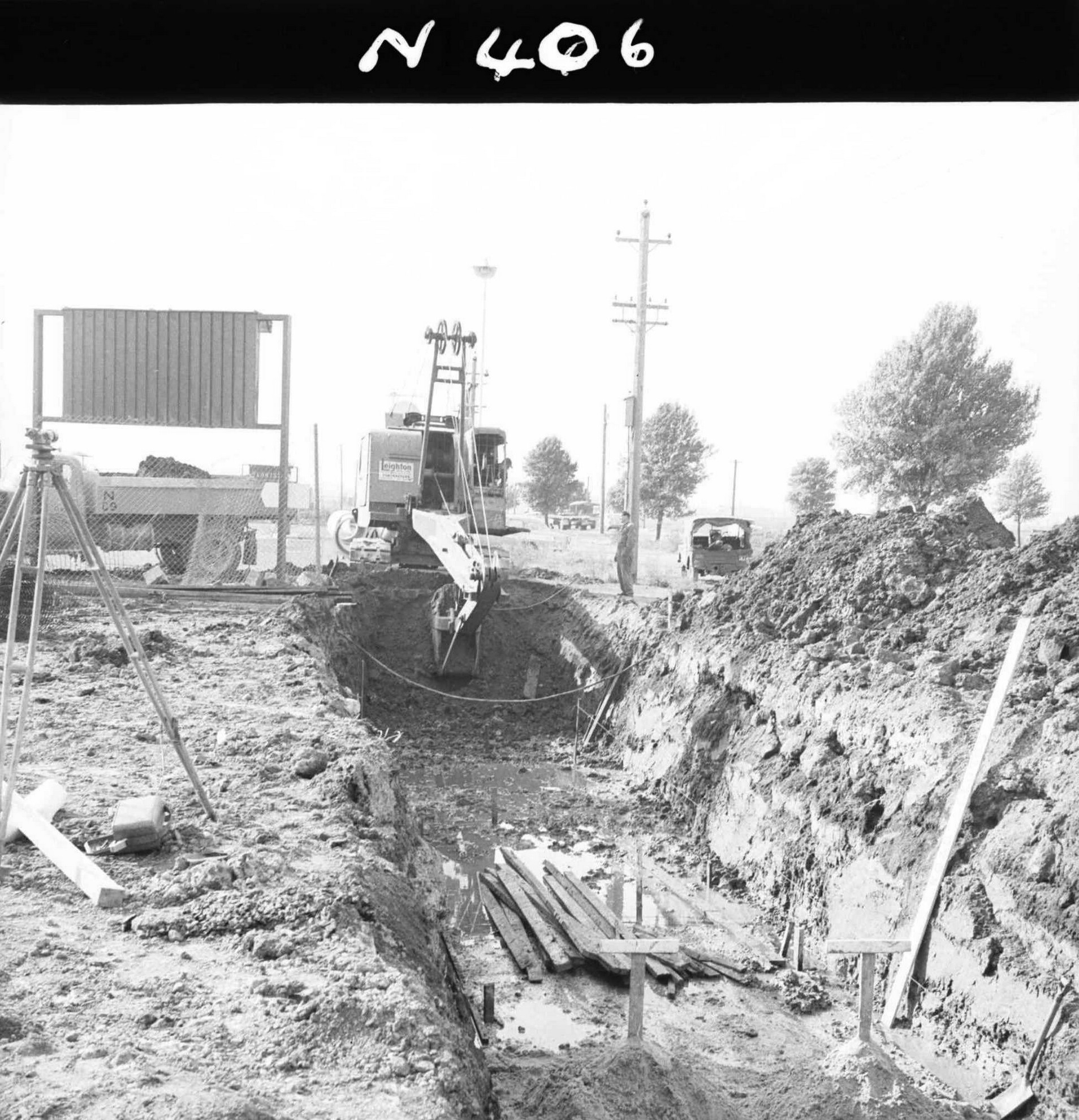 N406 Image showing a back actor excavating a trench during drain ...